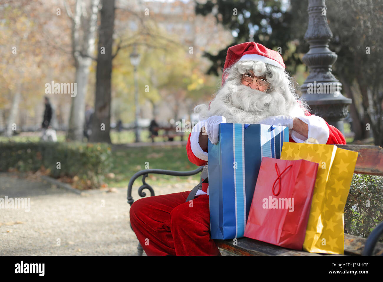 Santa Claus with gifts sitting outside Stock Photo - Alamy