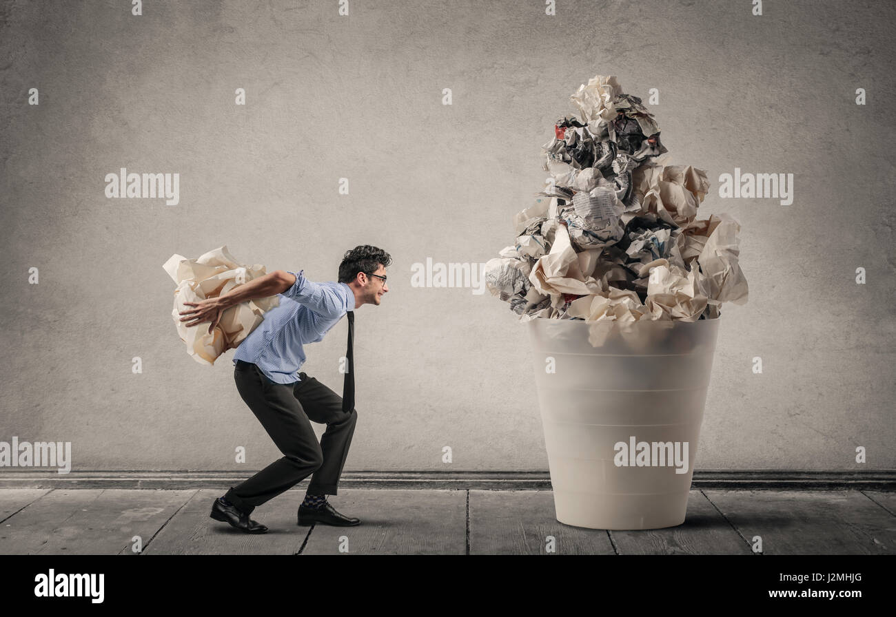 Man carrying trash to bin Stock Photo - Alamy