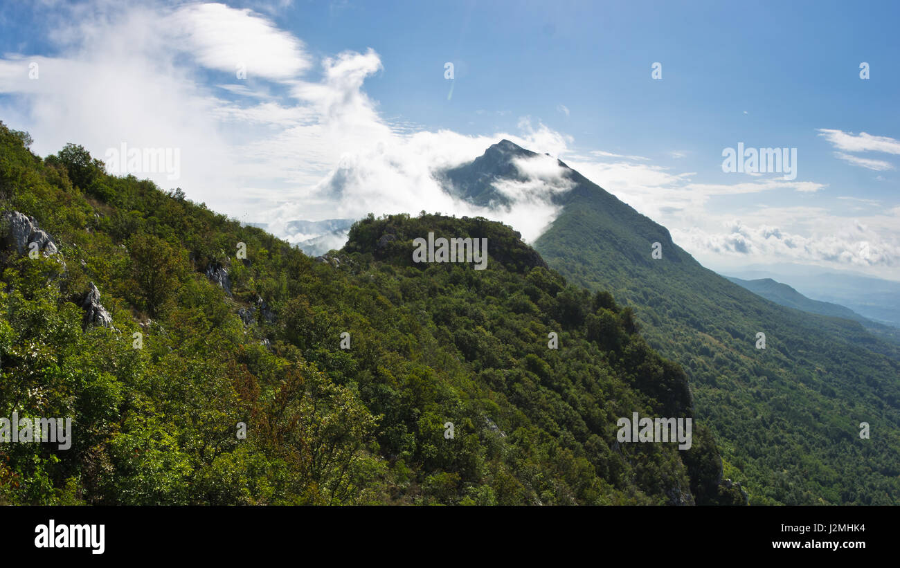 Mountain peaks of Suva Planina at sunny morning covered with clouds in ...