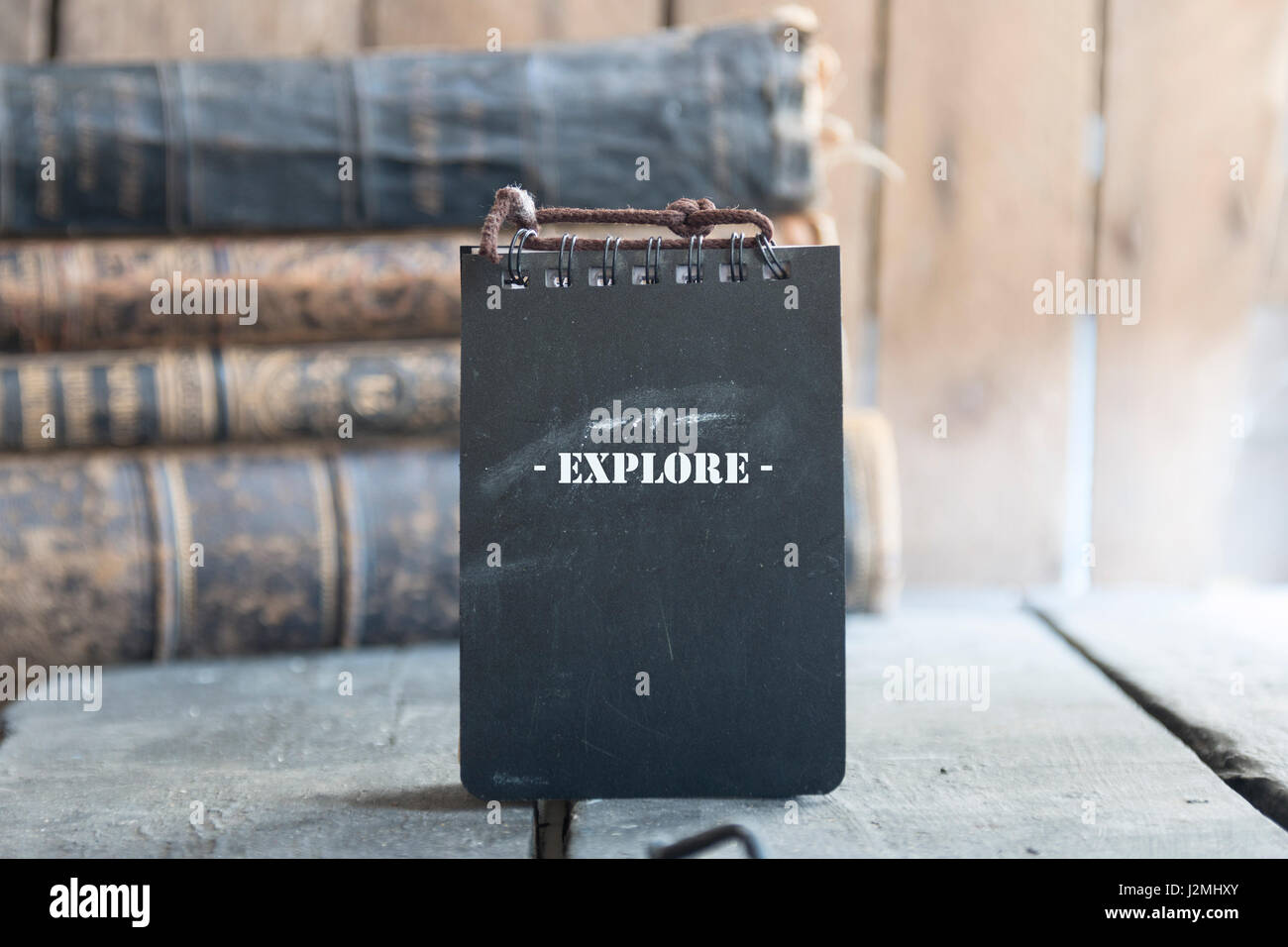 explore - lettering on the label and old books Stock Photo - Alamy
