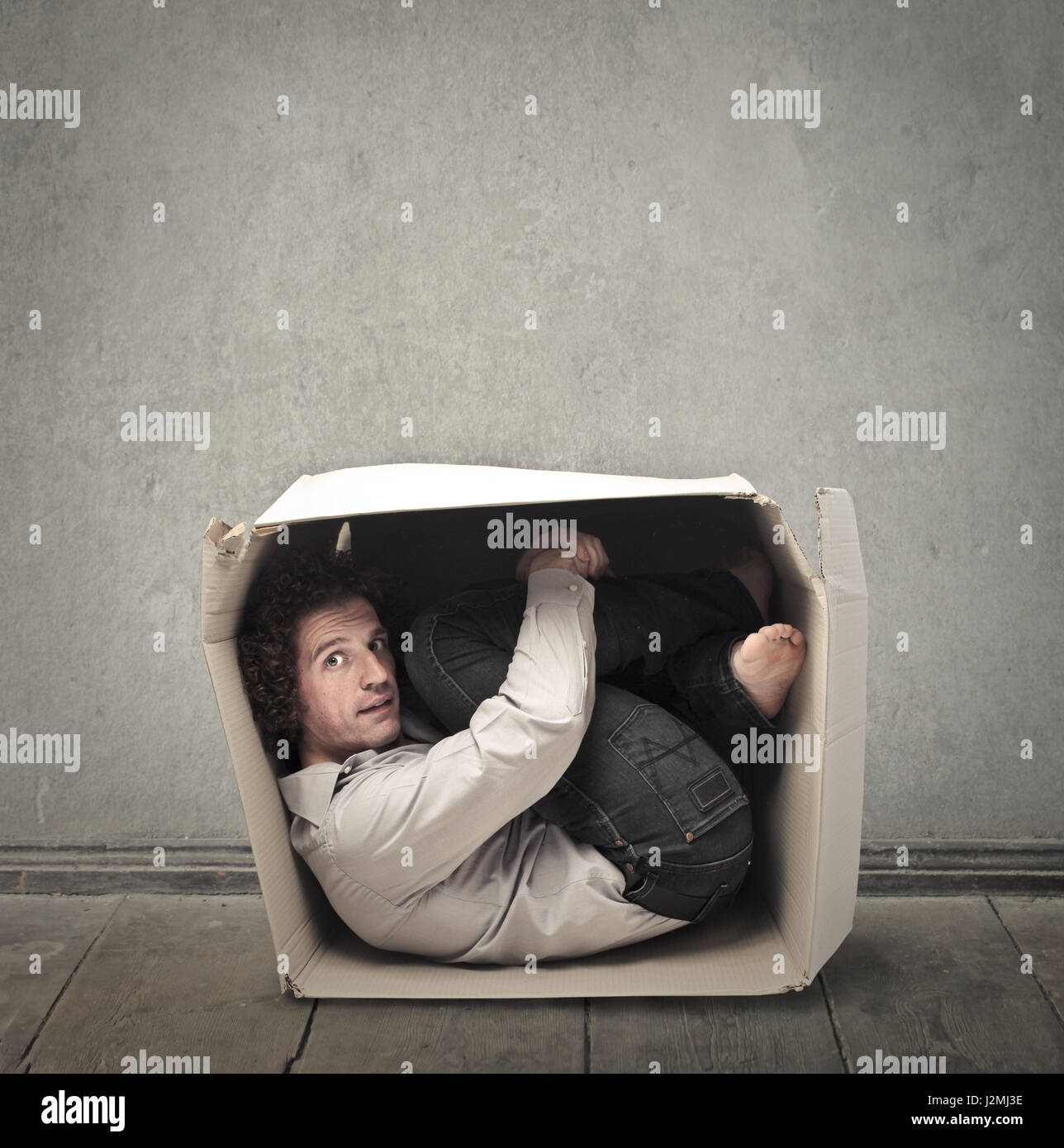 Man laying in box Stock Photo - Alamy