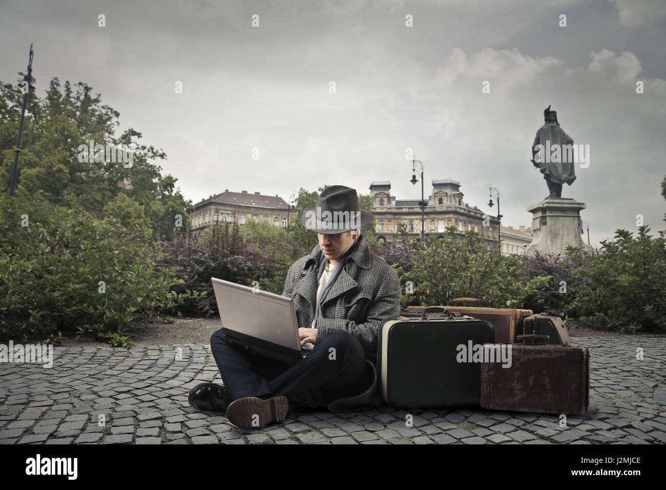 Mysterious man with laptop outside Stock Photo - Alamy
