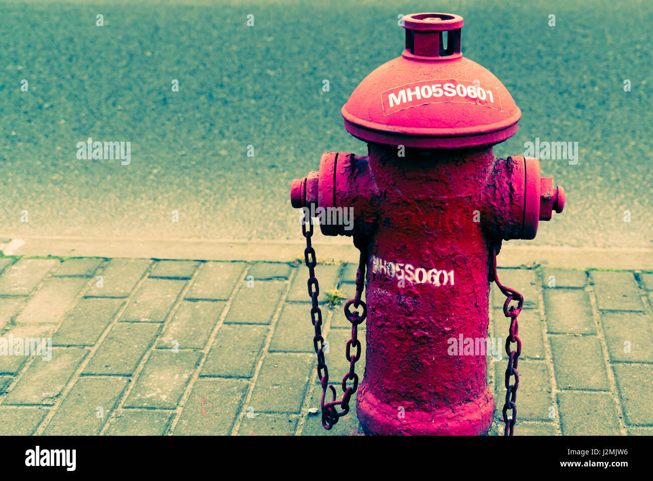 Red fire water hydrant beside the road - hipster filter and noise grain ...