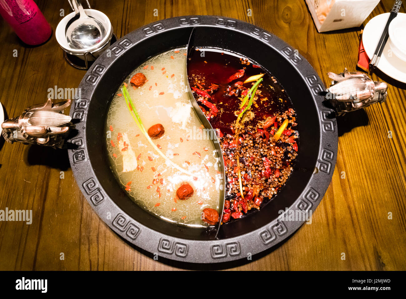 Shabu pot in Chinese style - pork soup and oily spicy soup Stock Photo ...
