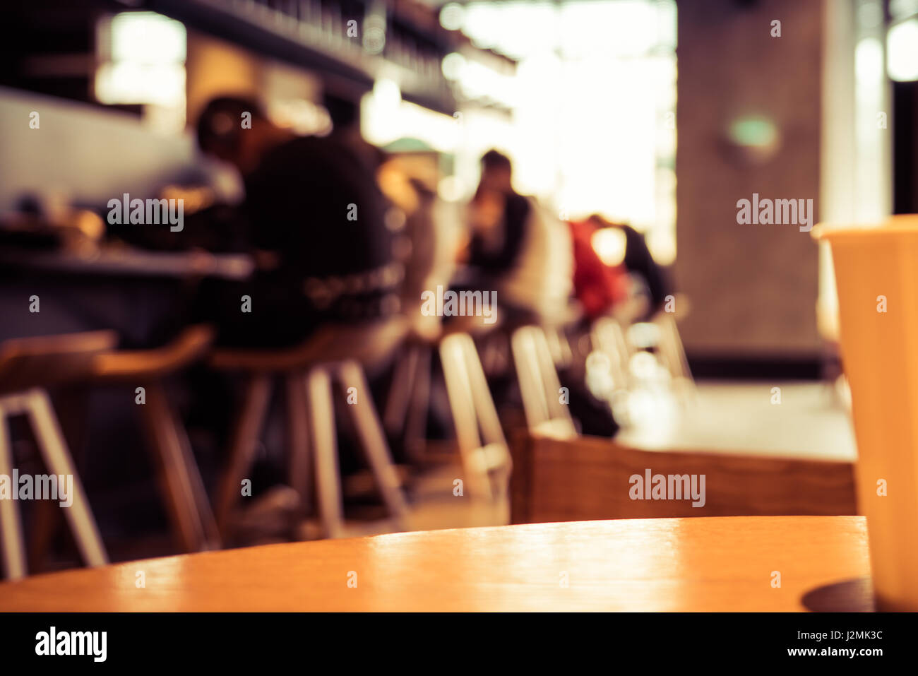 A cup of coffee - cafe blur background with warm tones Stock Photo - Alamy