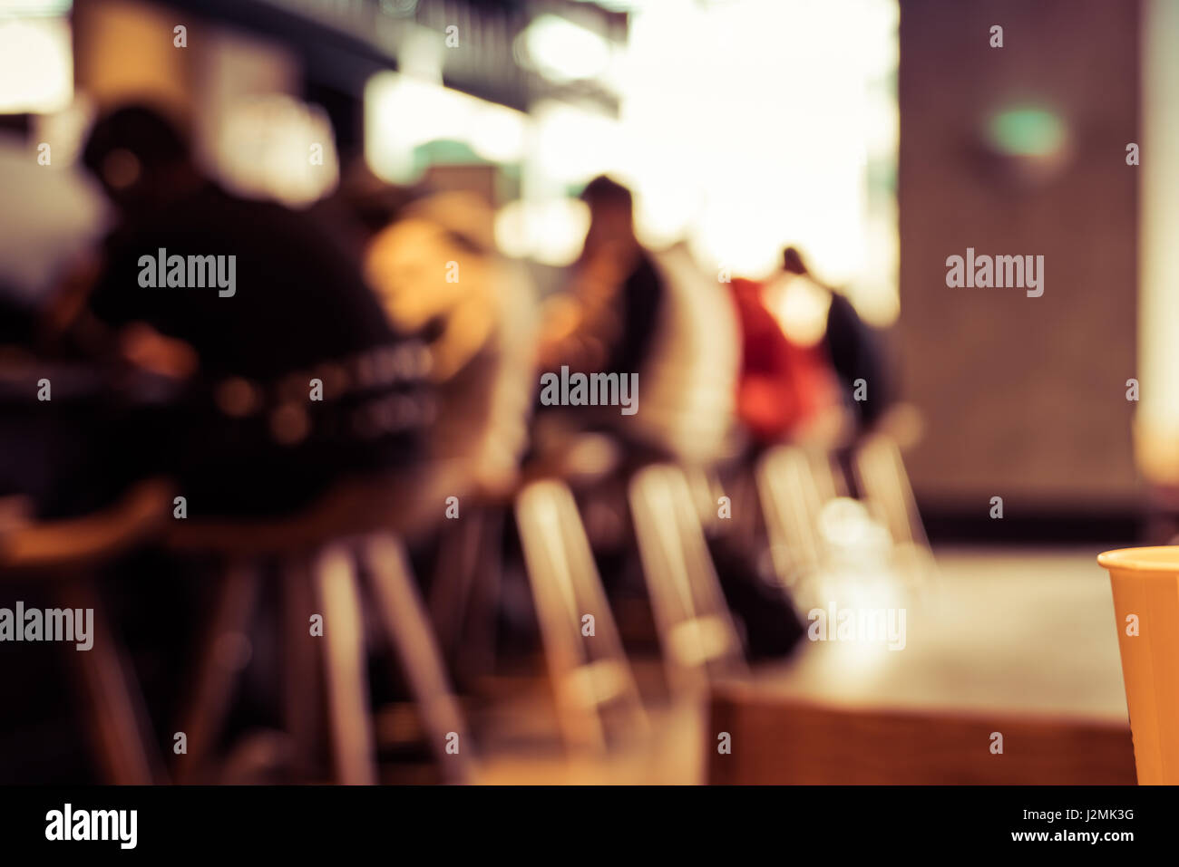 A cup of coffee - cafe blur background with warm tones Stock Photo - Alamy