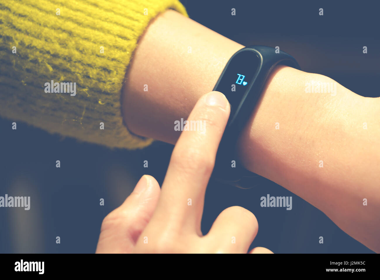 Women touching fitness smart band on her hand Stock Photo - Alamy