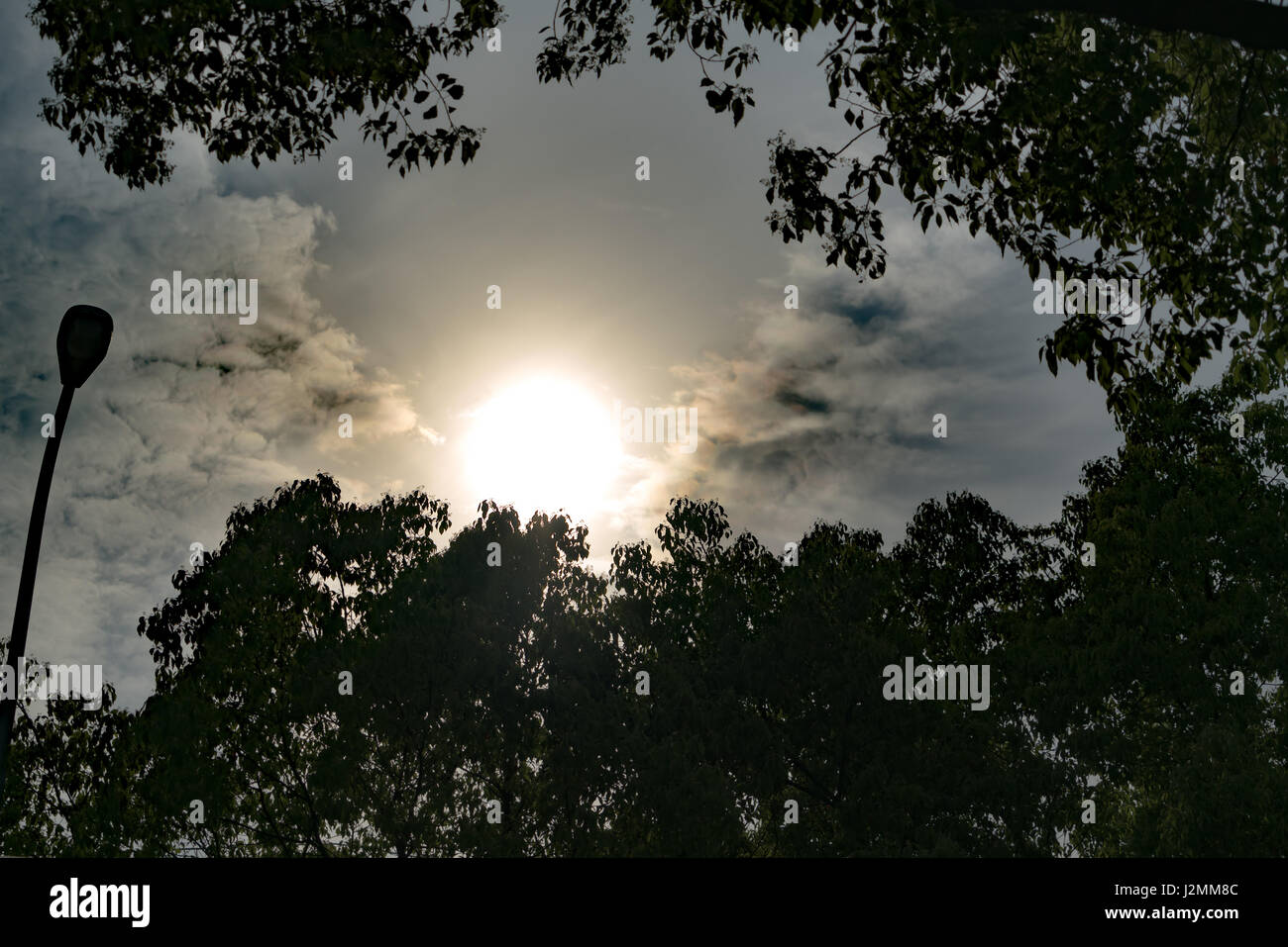 dramatic sun rays through dark sky, with filter Stock Photo - Alamy