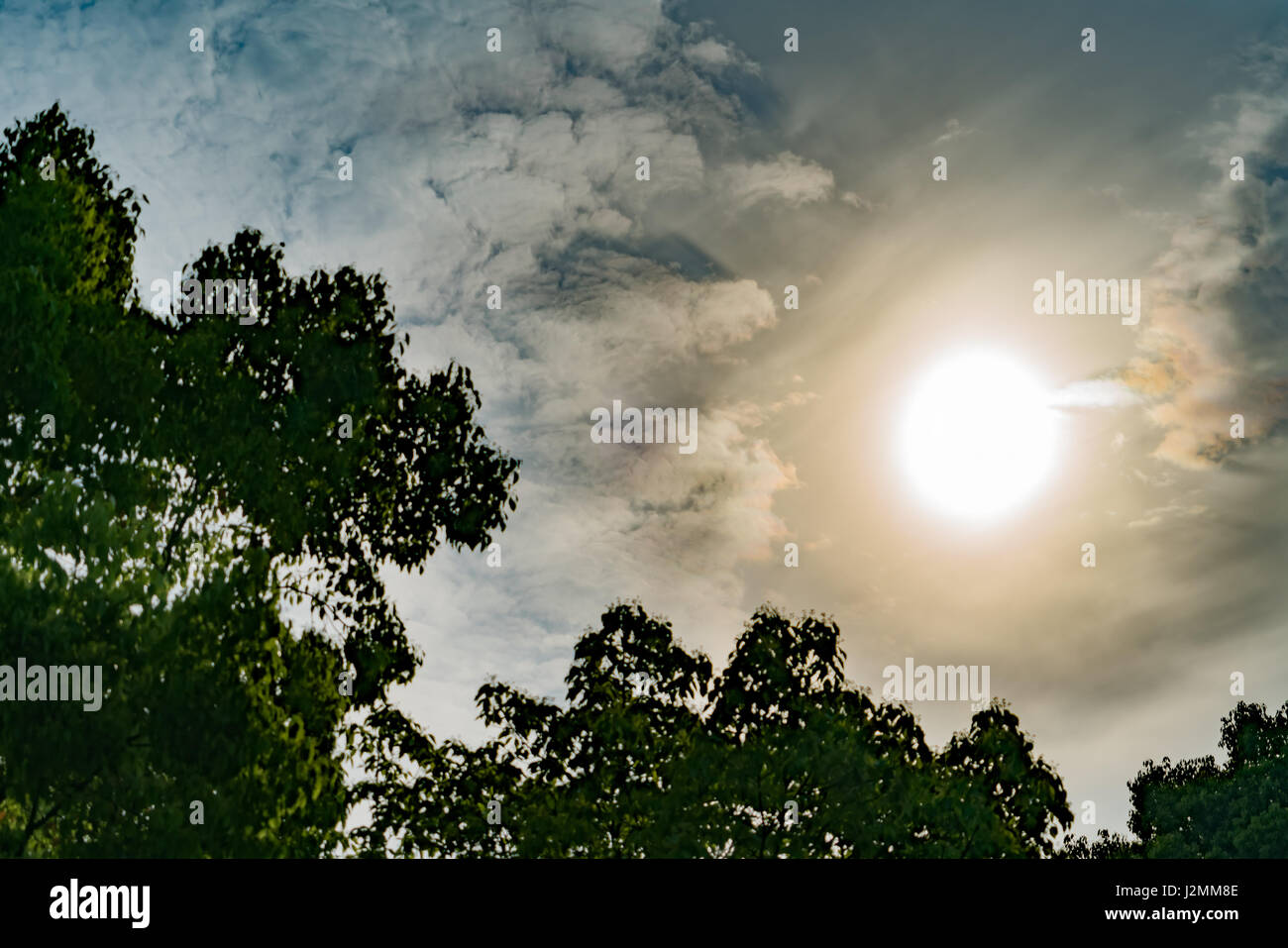 dramatic sun rays through dark sky, with filter Stock Photo - Alamy