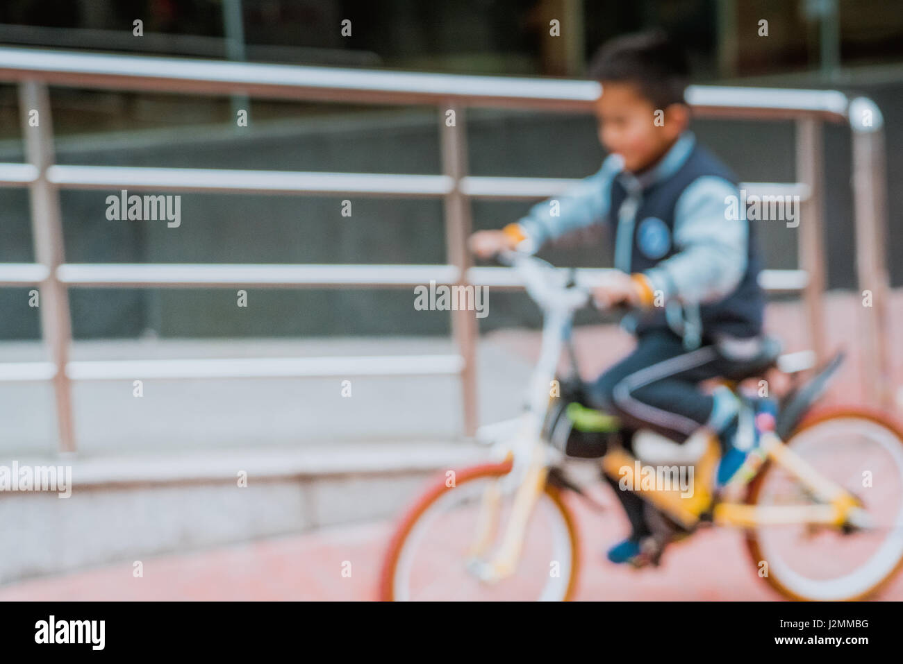 Blurred photo of asian boy riding bicycle in winter season Stock Photo ...