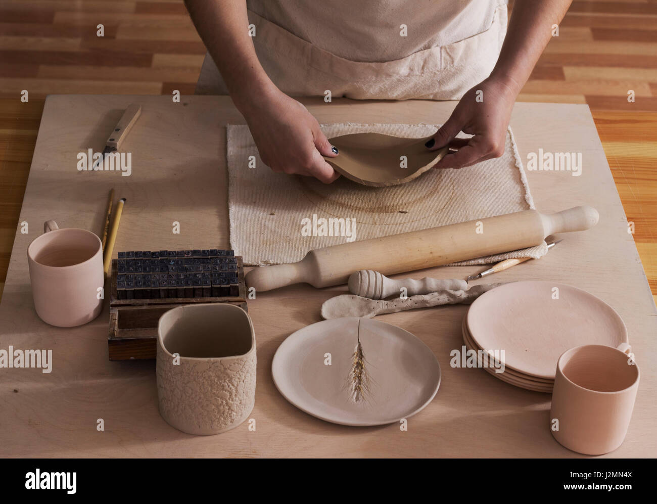 Ceramist finishing a plate Stock Photo - Alamy