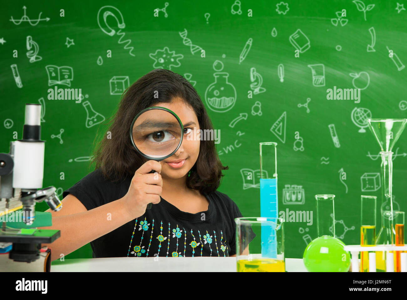 cute indian kids doing science experiment in chemistry lab or biology ...