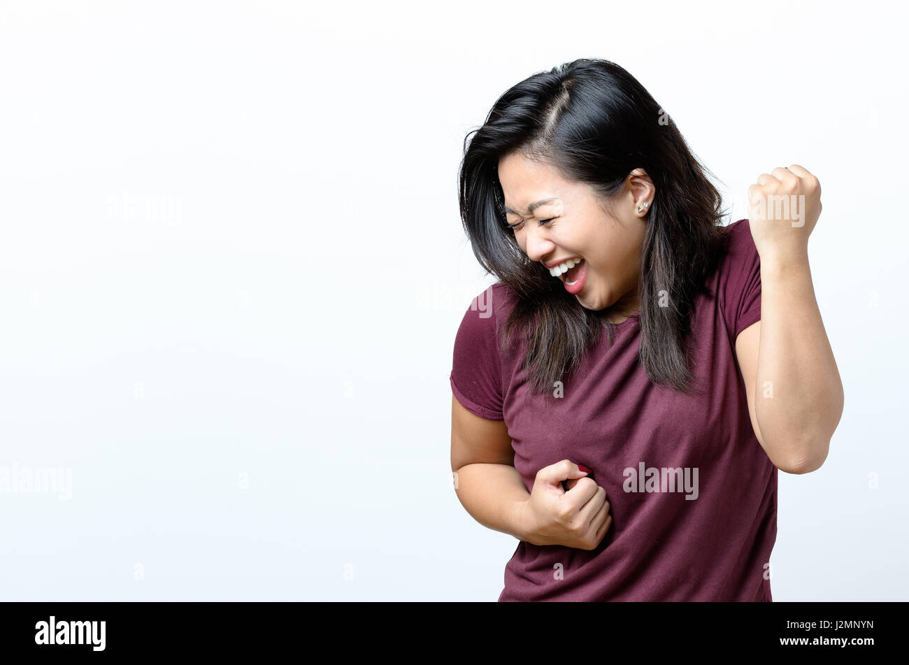 Exuberant exultant young Chinese woman cheering a victory, success or ...