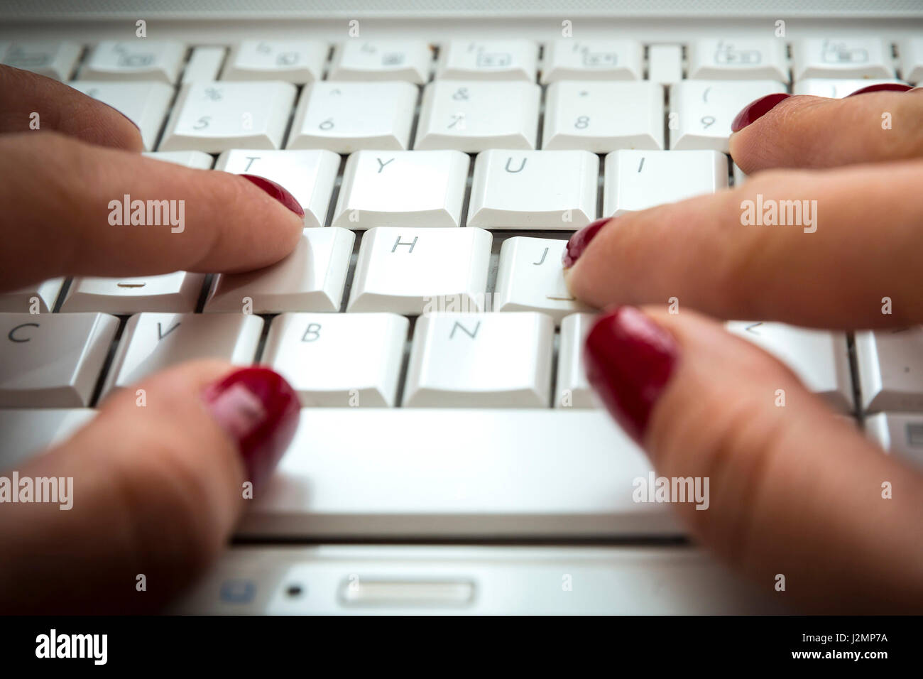 Computer keyboard and woman hands with red nail polish. Typing on the ...