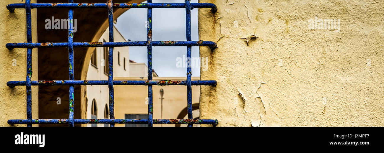A window looking in to a courtyard of an abandoned Navy building in San ...