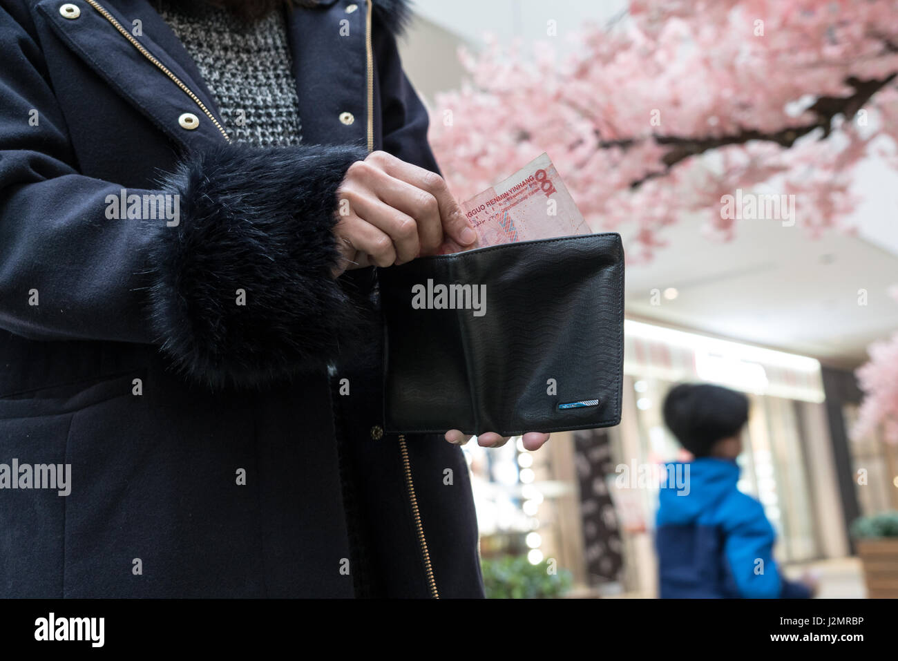 Hand holding last banknote in wallet. The woman show her last banknote ...