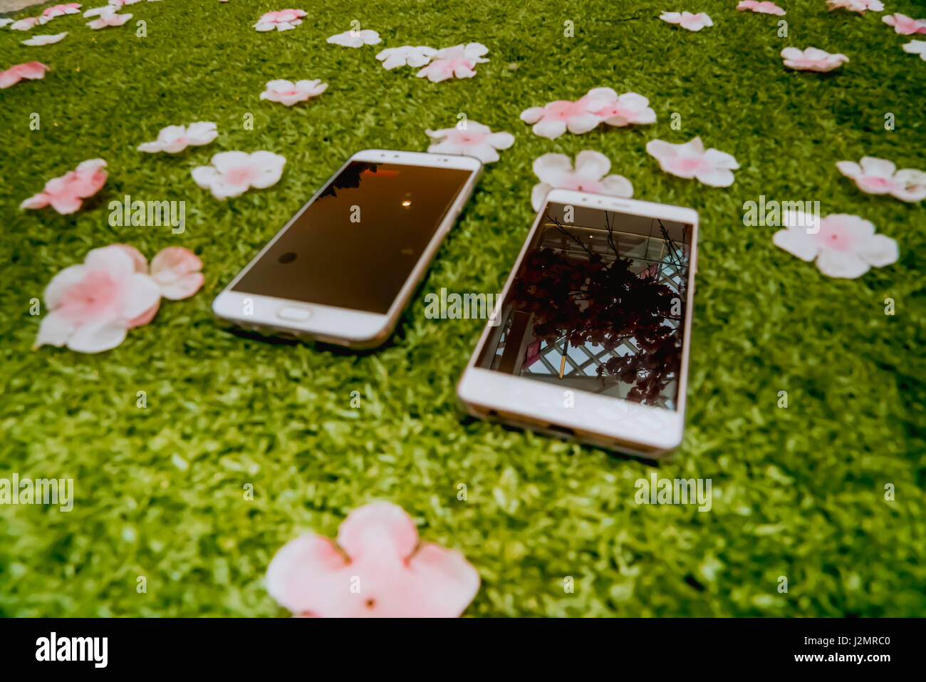 Couple smartphone on the ground Stock Photo - Alamy