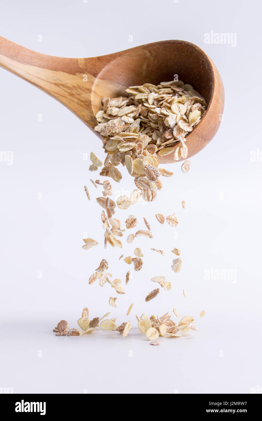 Spoon of oatmeal falling on a white background, isolated Stock Photo ...