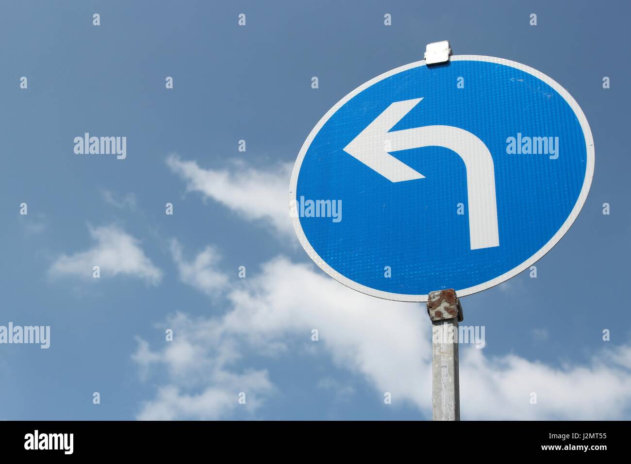German road sign: left turn Stock Photo - Alamy