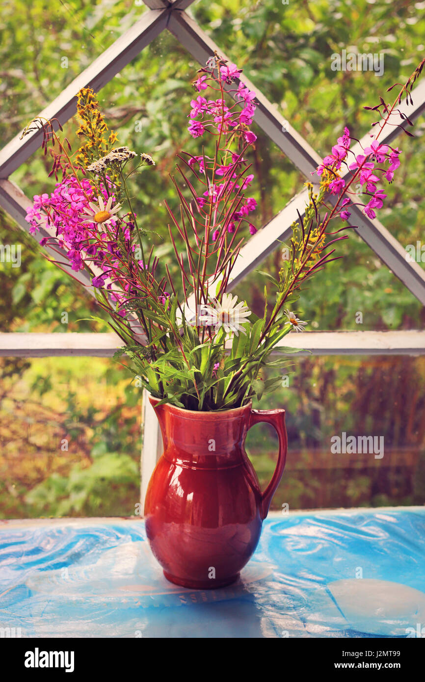 Bunch of wildflowers on a background of the rural window Stock Photo ...