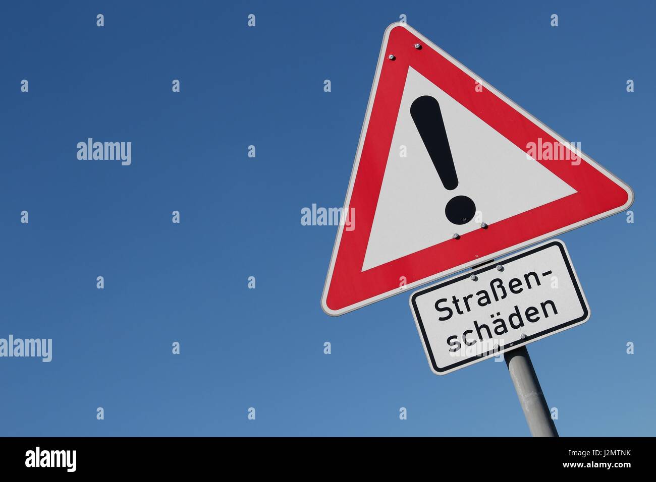 German road sign: caution - shaded road Stock Photo - Alamy