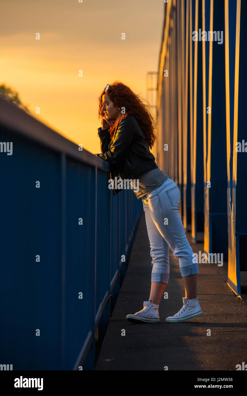 Beautiful red-haired girl enjoying the sunset Stock Photo - Alamy