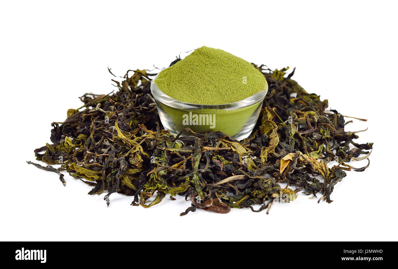 Dried tea leaf and powder with bowl isolated on white Stock Photo - Alamy