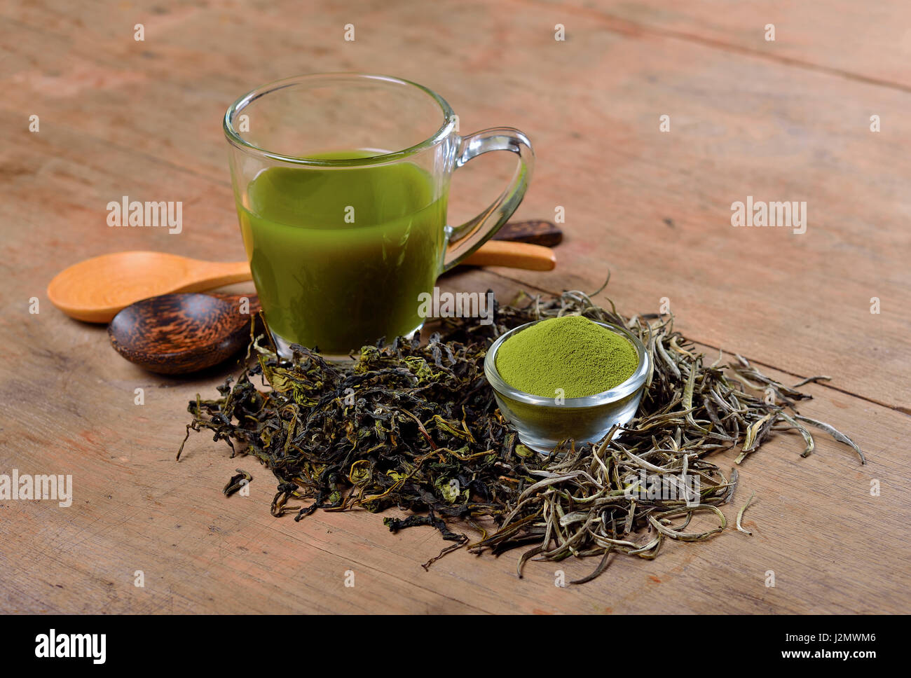 Dried tea leaf and powder with glass on wood Stock Photo - Alamy