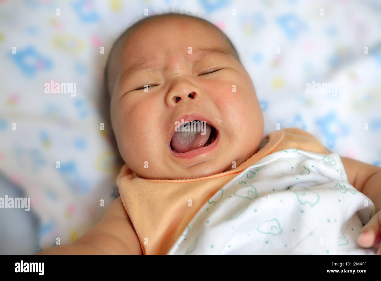 New born asian baby crying on bed Stock Photo - Alamy