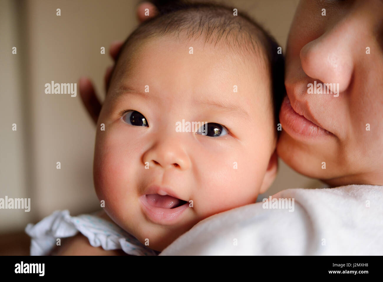 Mother carry the baby in arm Stock Photo - Alamy