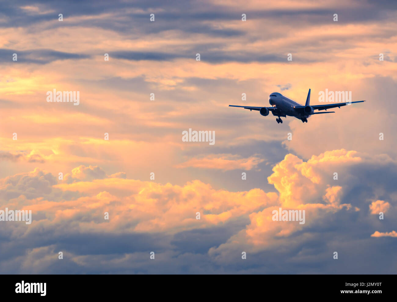 Commercial passenger airplane coming in for landing against beautiful ...