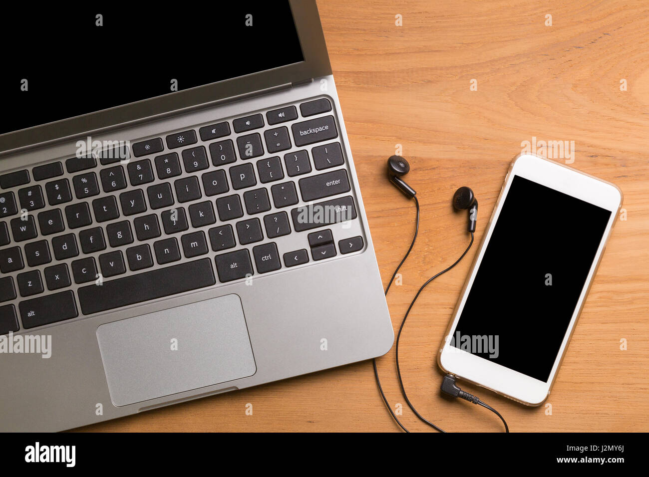 Portable computer laptop, smartphone, earphones, on wood table Stock ...