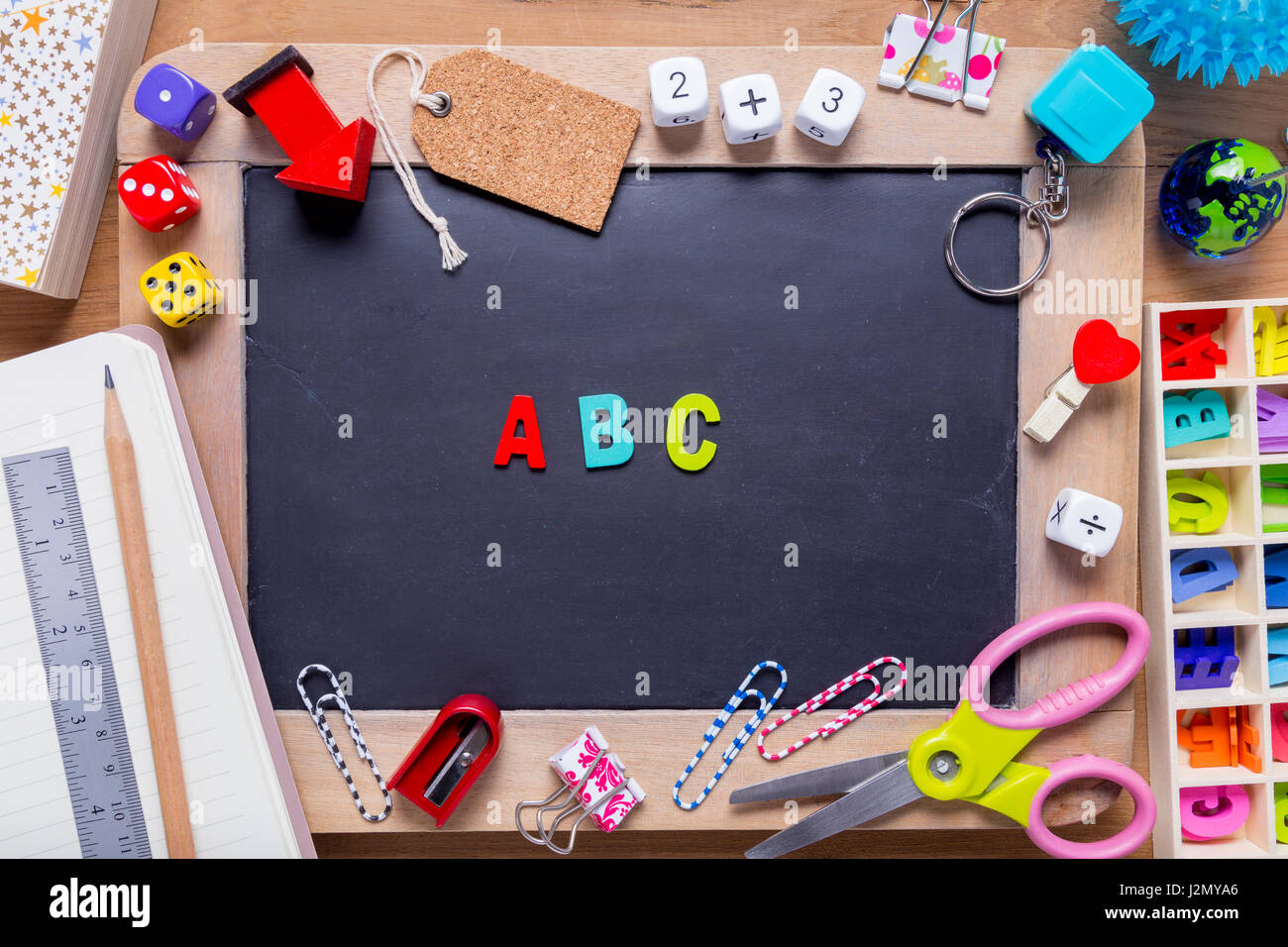 Small blackboard surrounded with various stationary with A B C ...