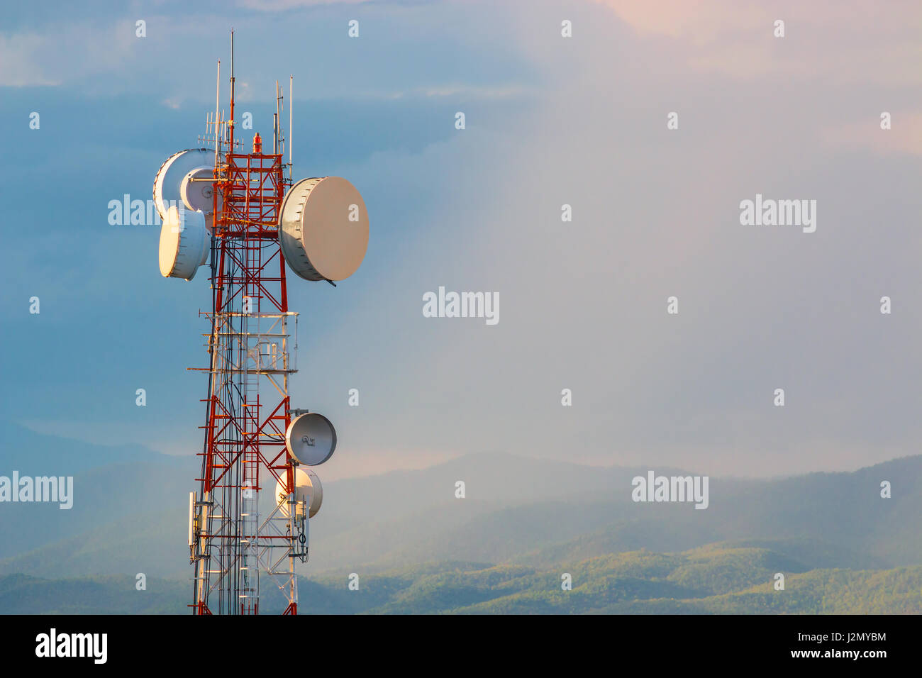 Telecommunication tower at sunset with warm sunlight hitting the tower ...