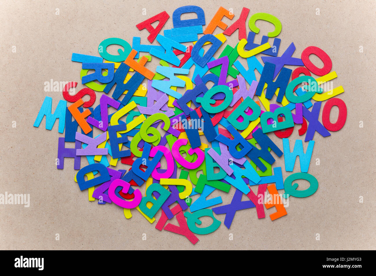 Random color wooden alphabets pile on wood background Stock Photo - Alamy