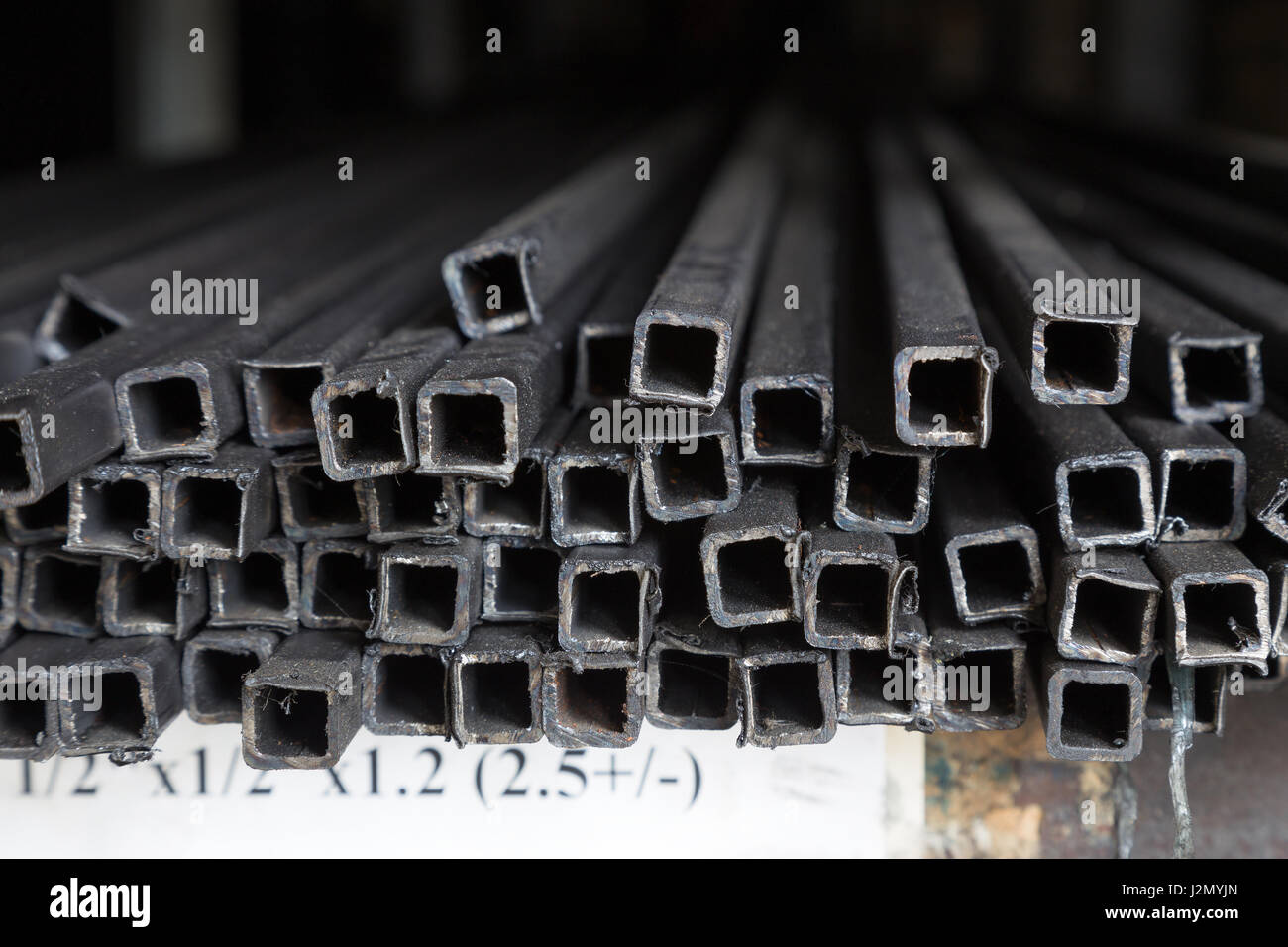 Close up of stack of square shape construction steel pipes, selective ...