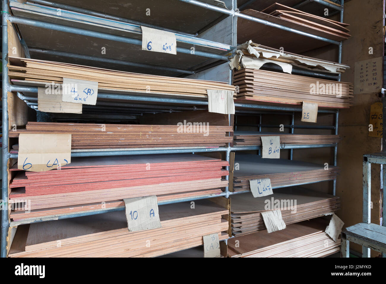 Racks of stacked construction plywood in various thickness and type ...