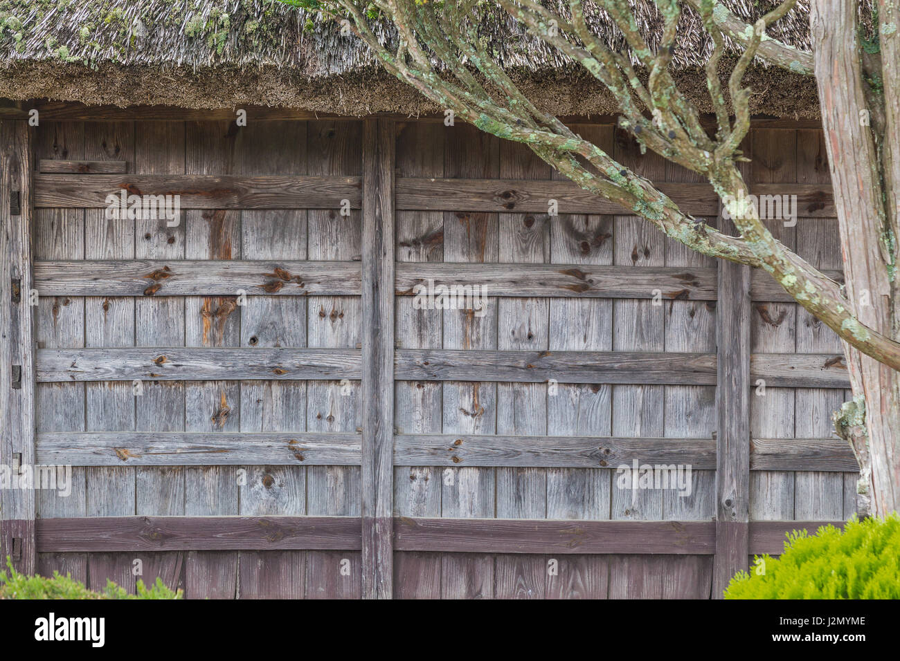 Old rustic Japanese house wood panel wall shown with small part of ...