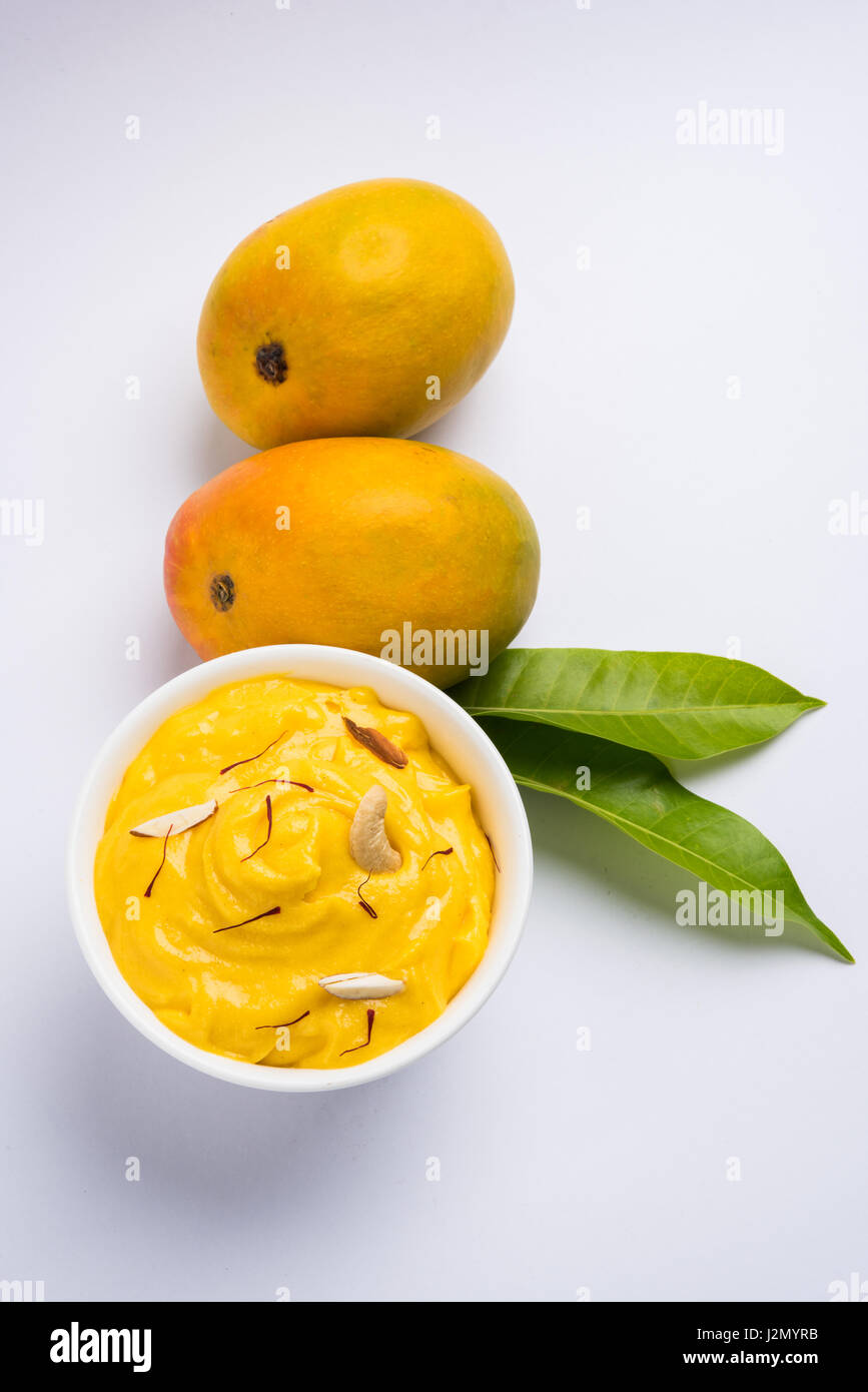 King of fruits; Alphonso yellow Mango fruit duo with stems and green ...