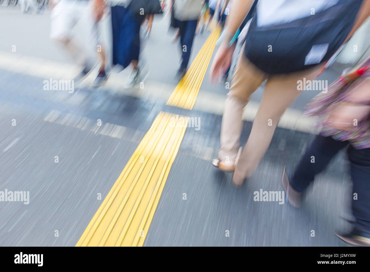 Motion blur image of people walking on the street, showing movement ...