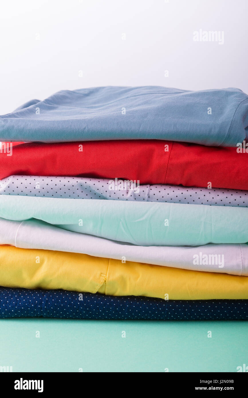 Folded colorful pants and jeans. Stack of bright female trousers. Close ...