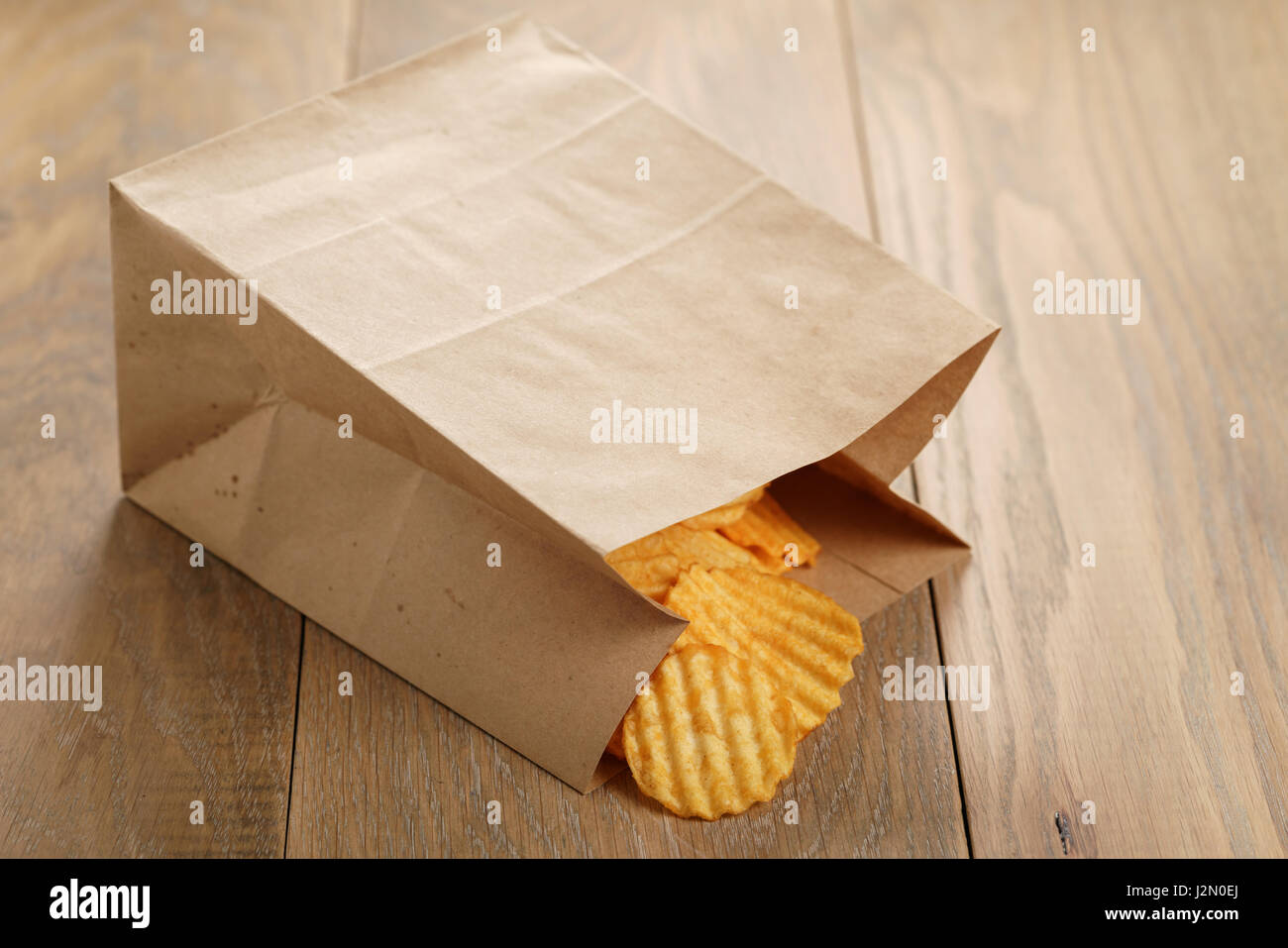rippled potato chips with paprika in paper bag, shallow focus Stock ...