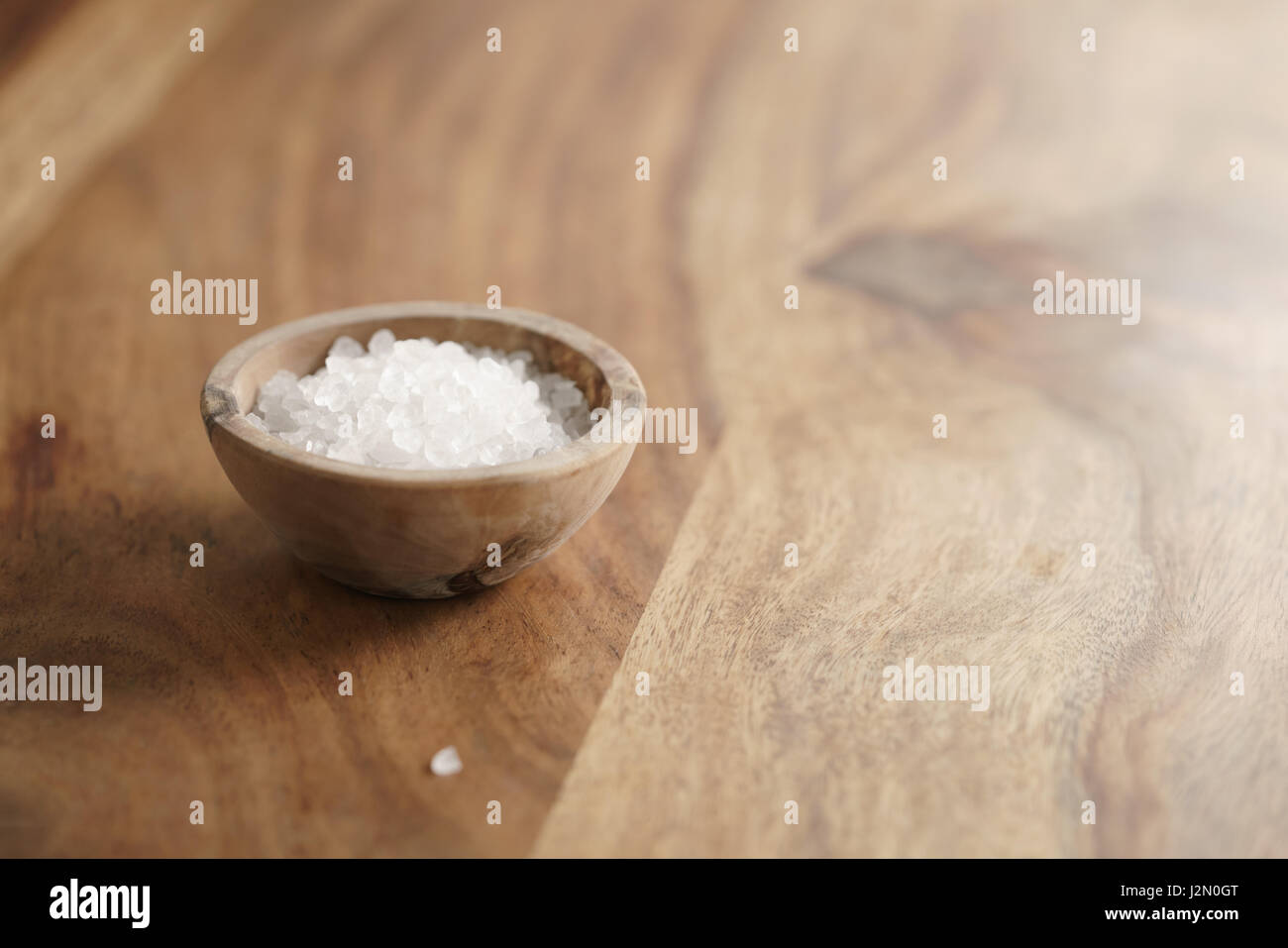 coarse sea salt in wooden bowl on table, with copy space Stock Photo ...