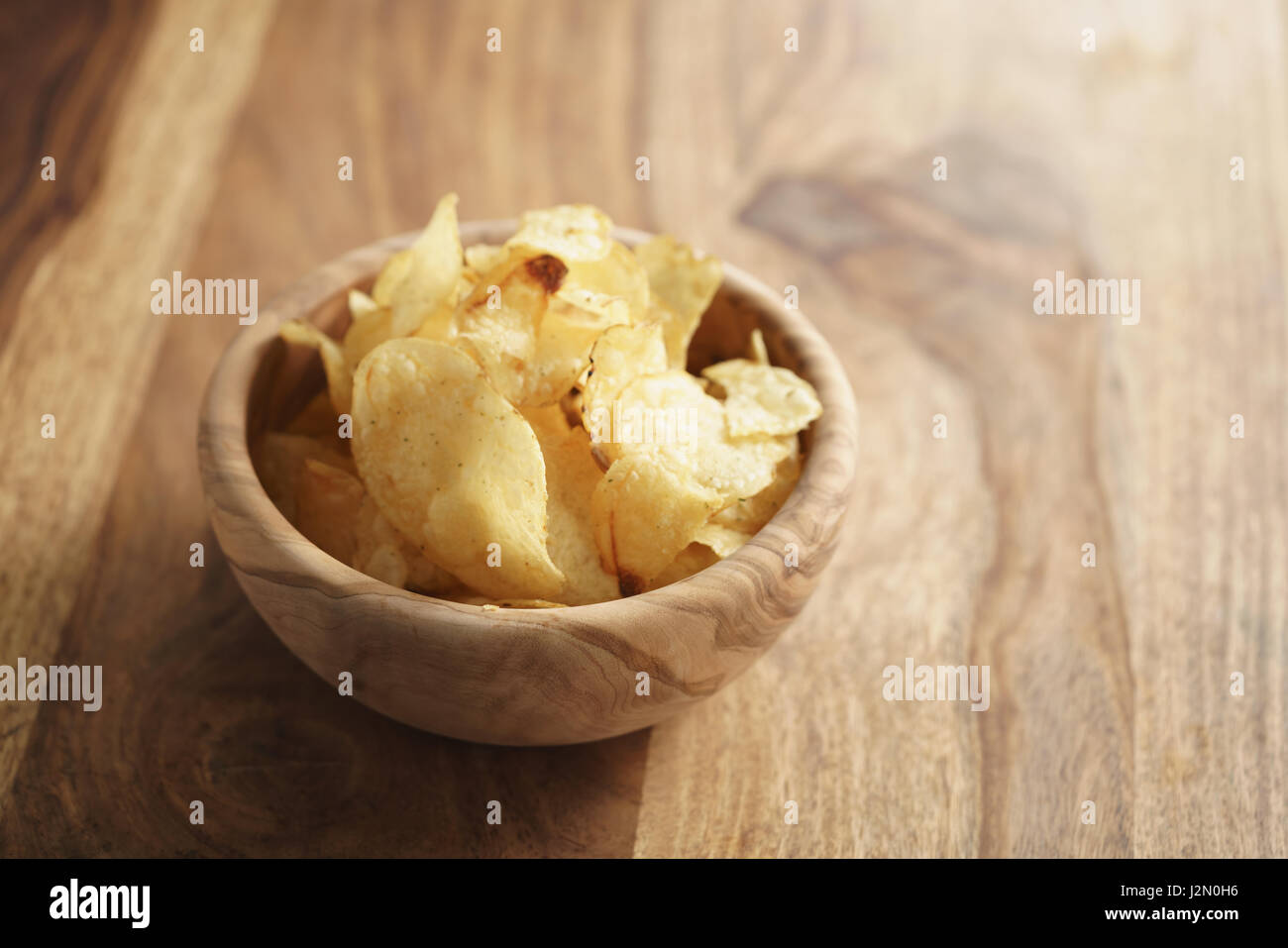 potato chips with herbs in wood bowl on rustic table Stock Photo - Alamy