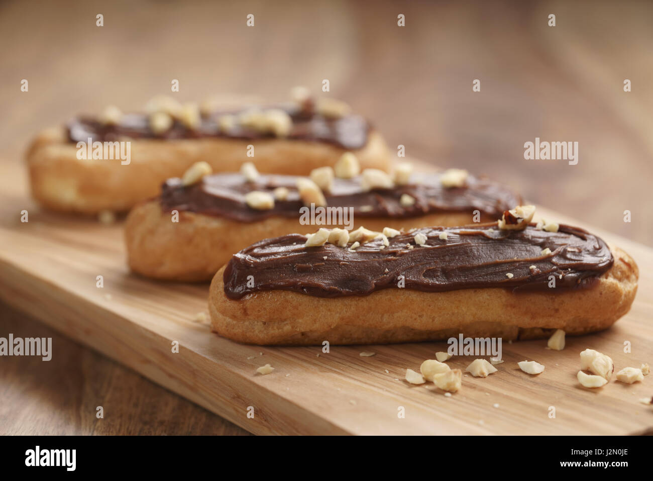 traditional french eclairs with chocolate and hazelnuts, shallow focus ...