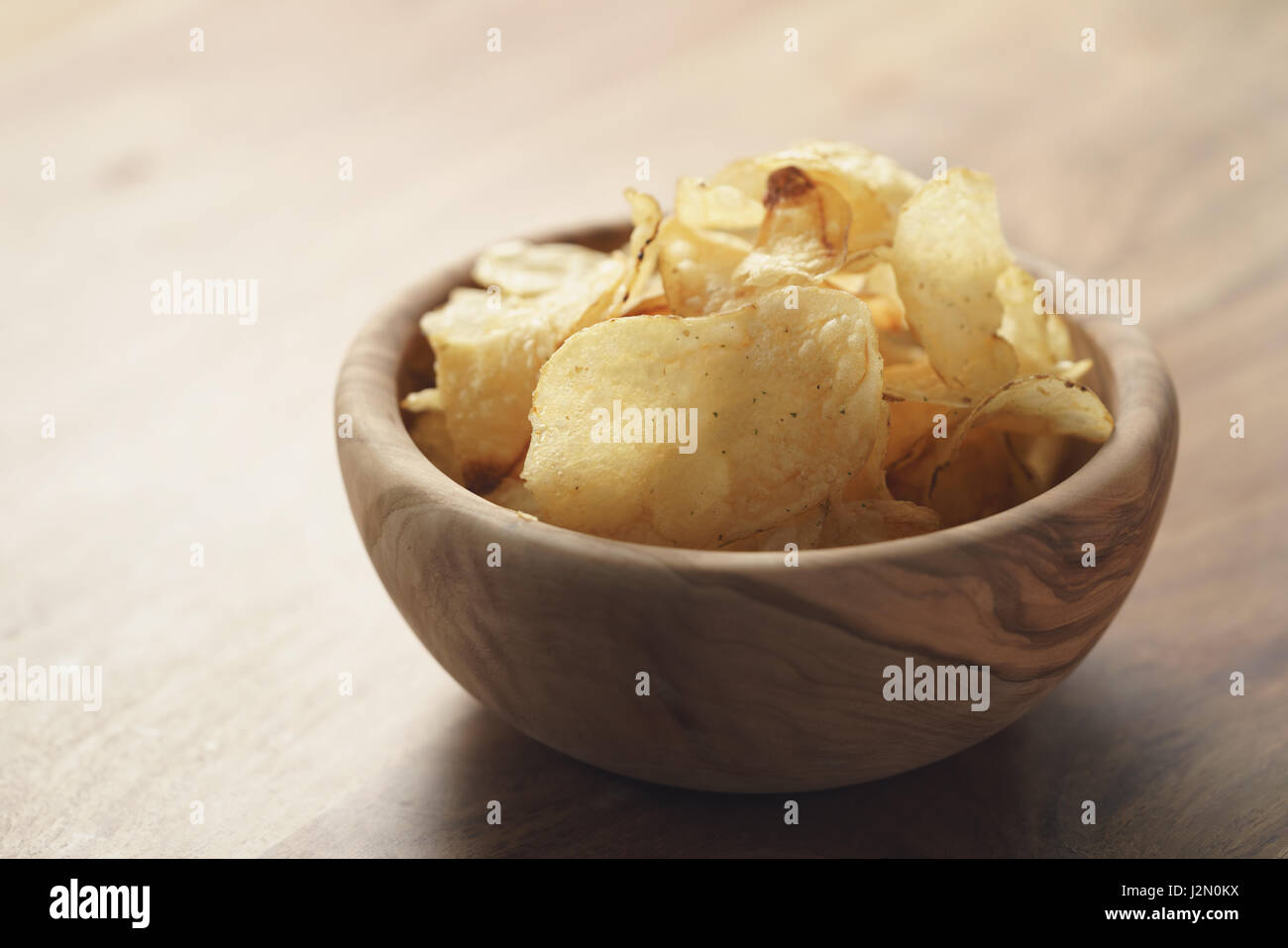 potato chips with herbs in wood bowl on rustic table Stock Photo - Alamy