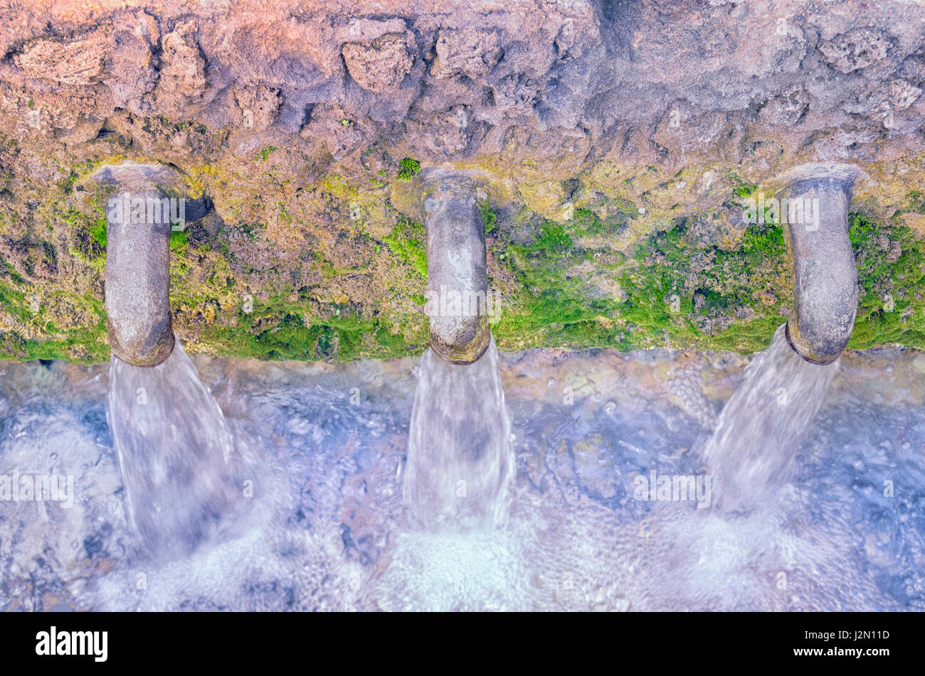 Top view of fountain with three faucets. Strong volume of water ...