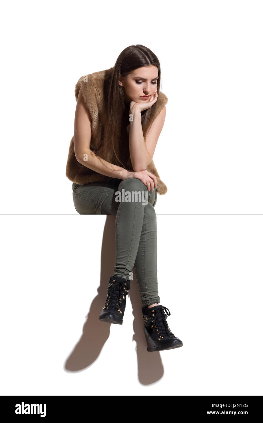 Young woman crossed legs sitting sad hi-res stock photography and ...