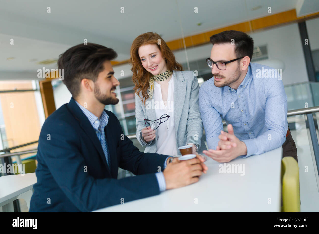 Business partners and colleagues having conversation during coffee ...