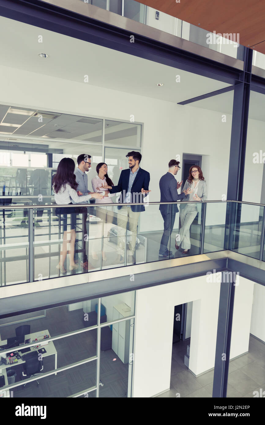 Group of business people having conversation at office building Stock ...